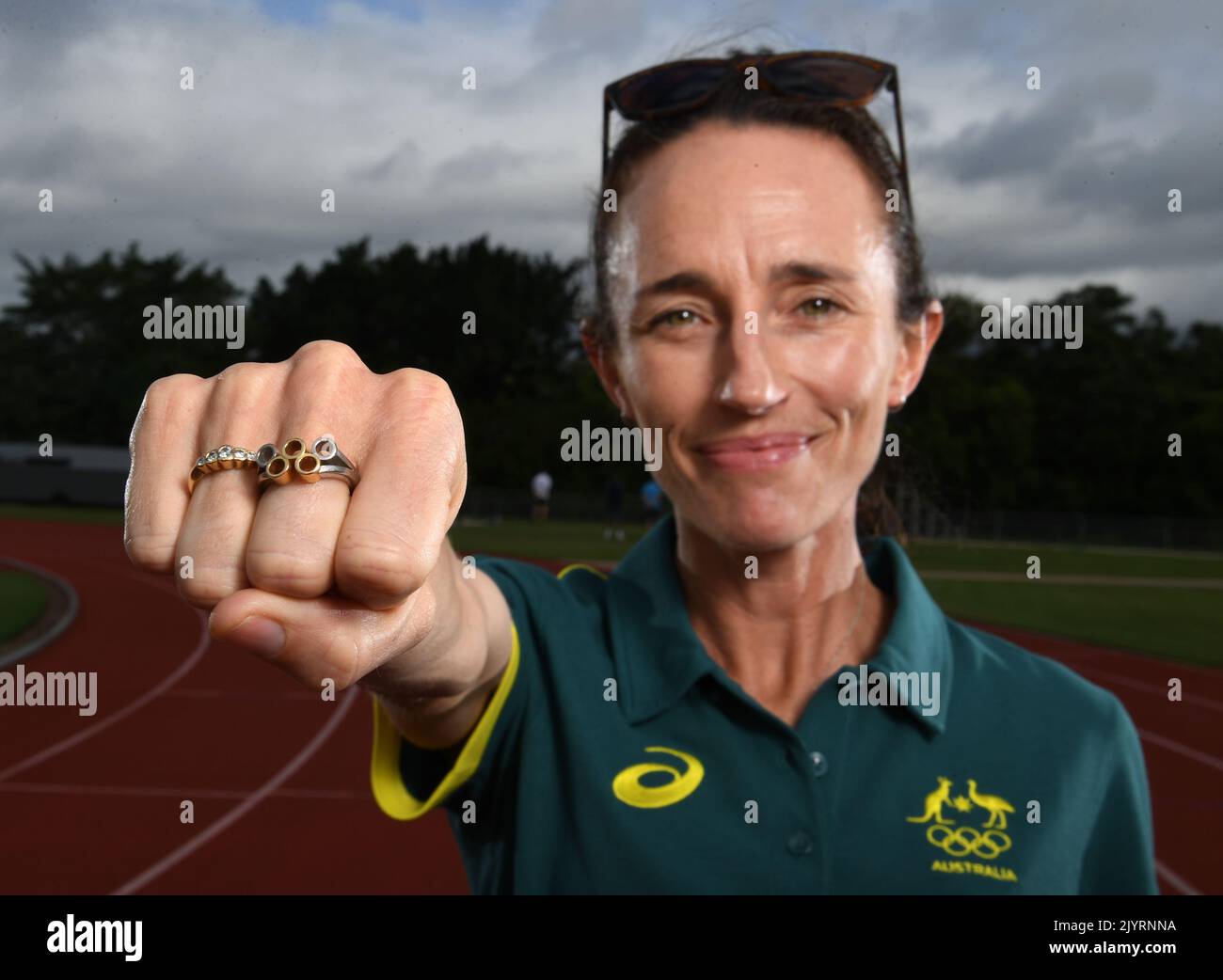 A ring made up of the Olympic rings is seen on the hand of Marathon ...