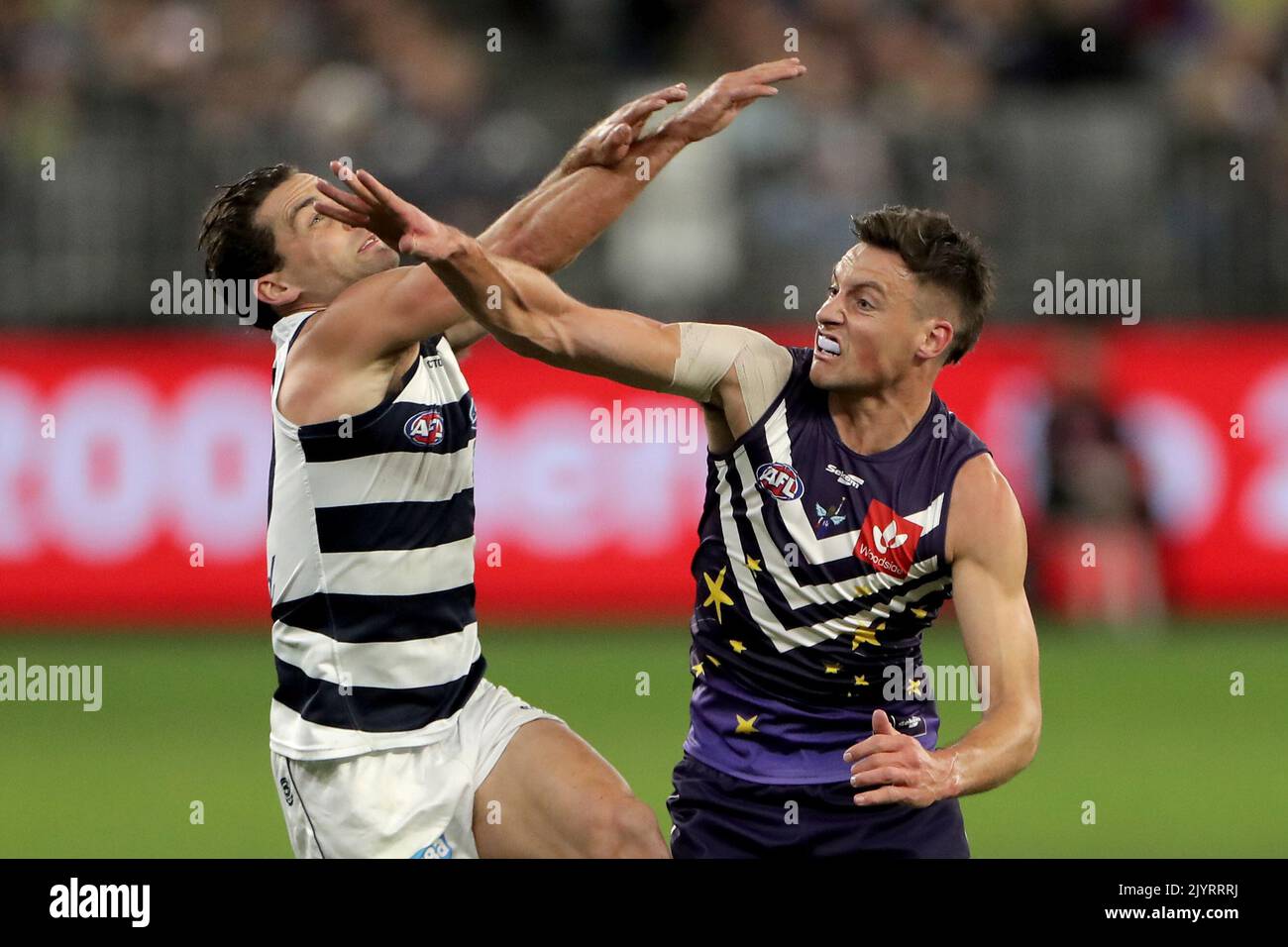 Luke Dahlhaus of the Cats and Ethan Hughes of the Dockers compete for ...