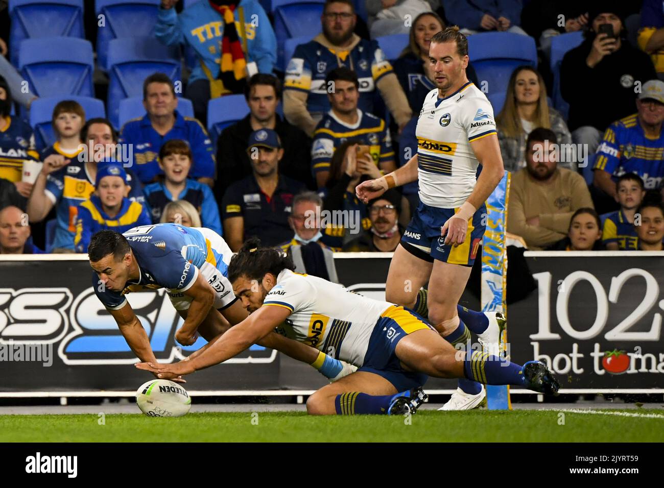 Corey Thompson of the Titans (left) knocks on ahead go Isaiah Papali’i ...