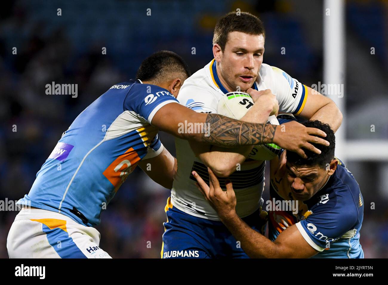 Tom Opacic of the Eels (centre) is tackled during the Round 18 NRL ...