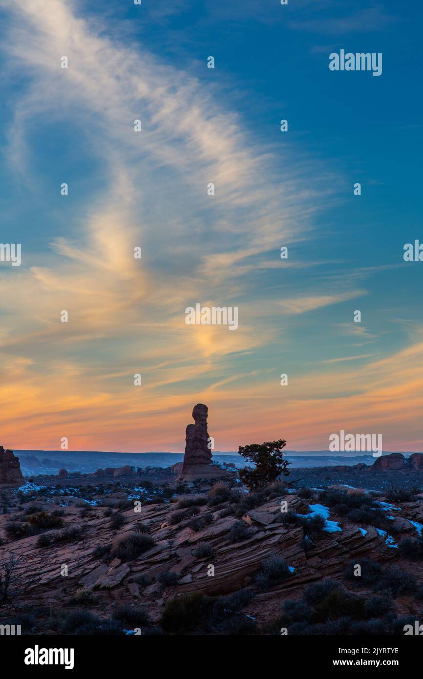 An unnamed Entrada sandstone rock spire with colorul sunset sky in ...