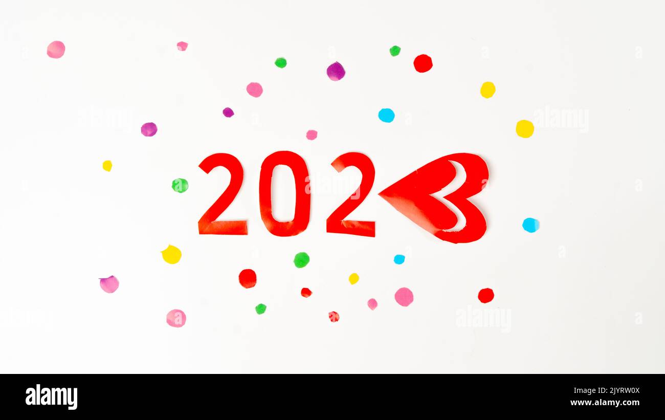 The number 2023 in red in multi-colored confetti, new year with love ...