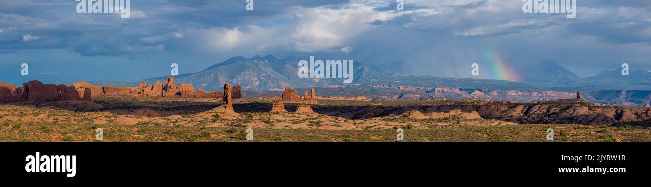 Panoramic view of Arches National Park with a storm and rainbow on the ...