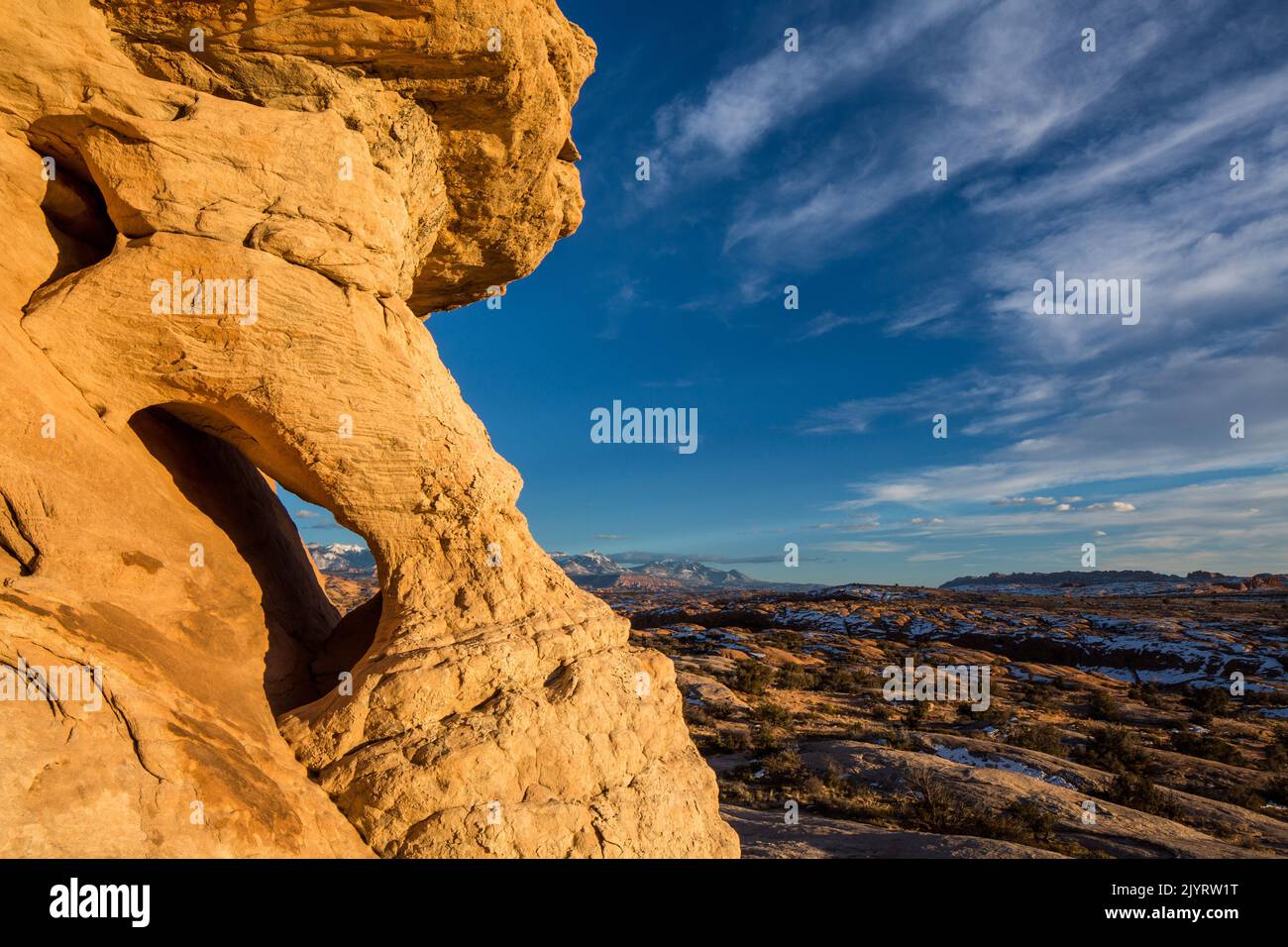 A small sandstone mini arch in Arches National Park with the La Sal ...