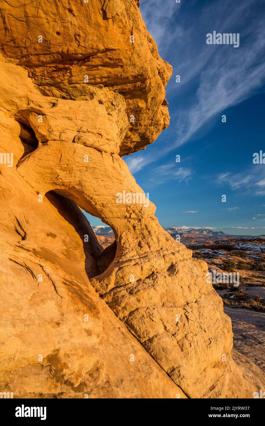 A small sandstone mini arch in Arches National Park with the La Sal ...