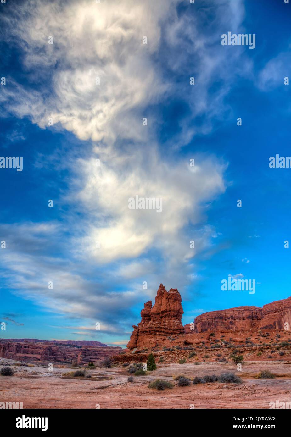 Clouds over an eroded Entrada sandstone formation on a base of Navajo ...