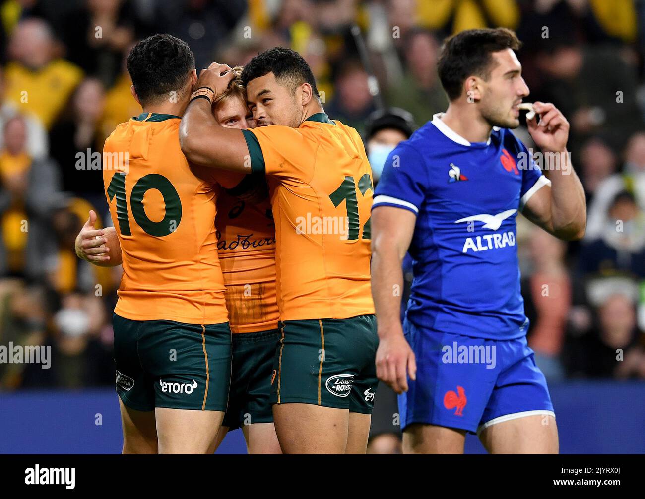 Tate McDermott of the Wallabies (2nd left) celebrates scoring a try ...