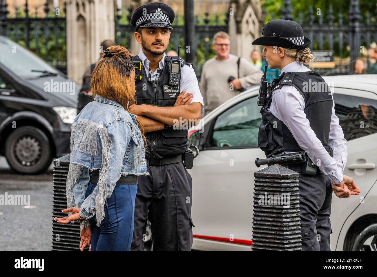 London, UK. 8th Sep, 2022. Police stop and handcuff a black woman, who ...