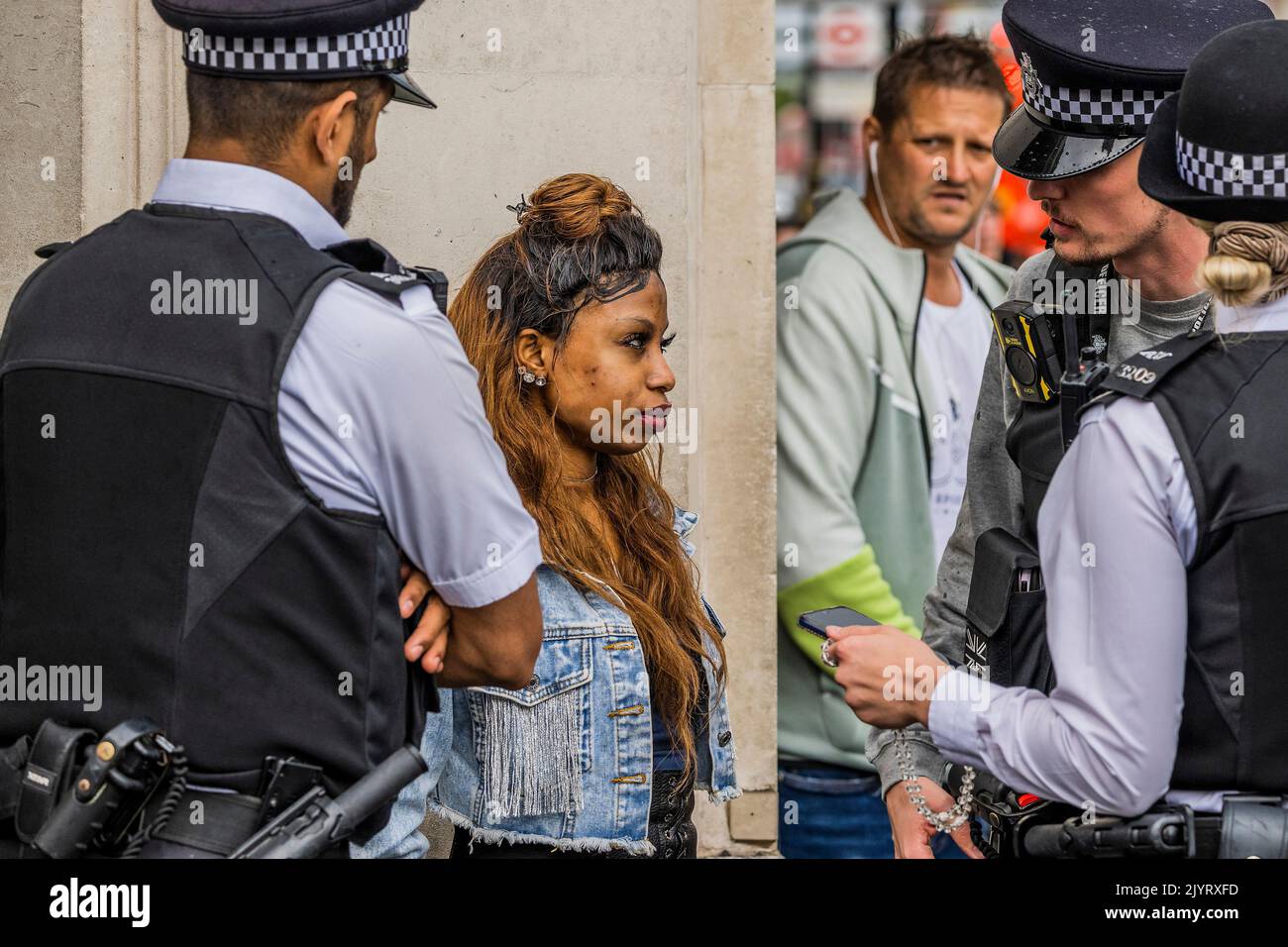 London, UK. 8th Sep, 2022. Police stop and handcuff a black woman, who ...