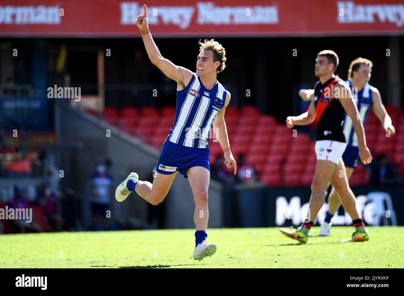 Charlie Lazzaro of the Kangaroos reacts after kicking a goal during the ...