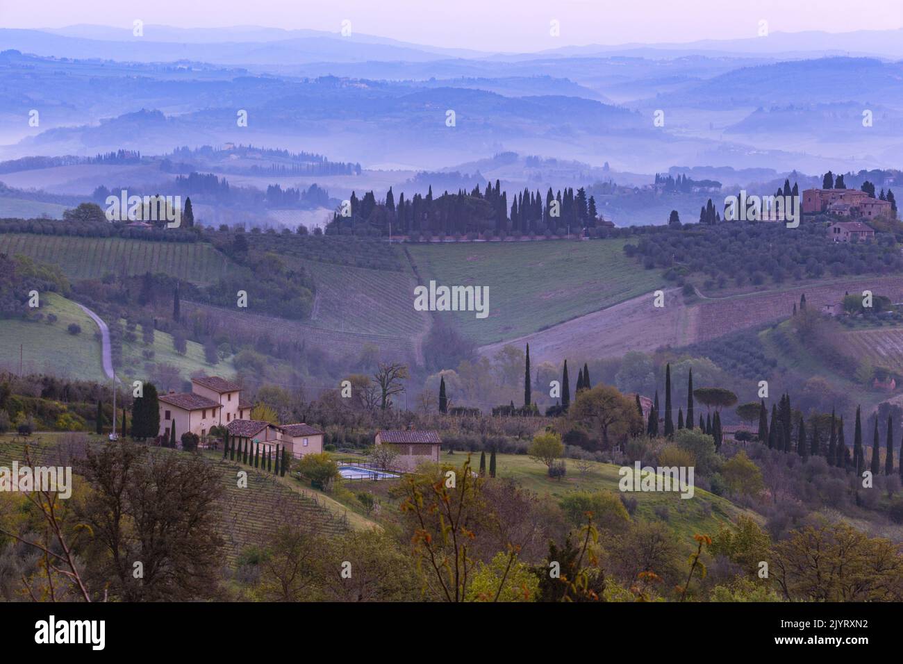 fog and typical Tuscan landscape - a view of a villa on a hill, a ...