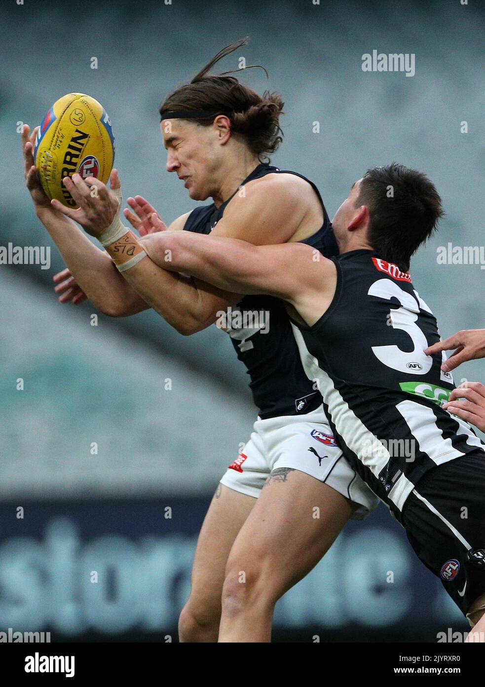 Liam Stocker of the Blues is tackled by Brayden Maynard of the Magpies ...