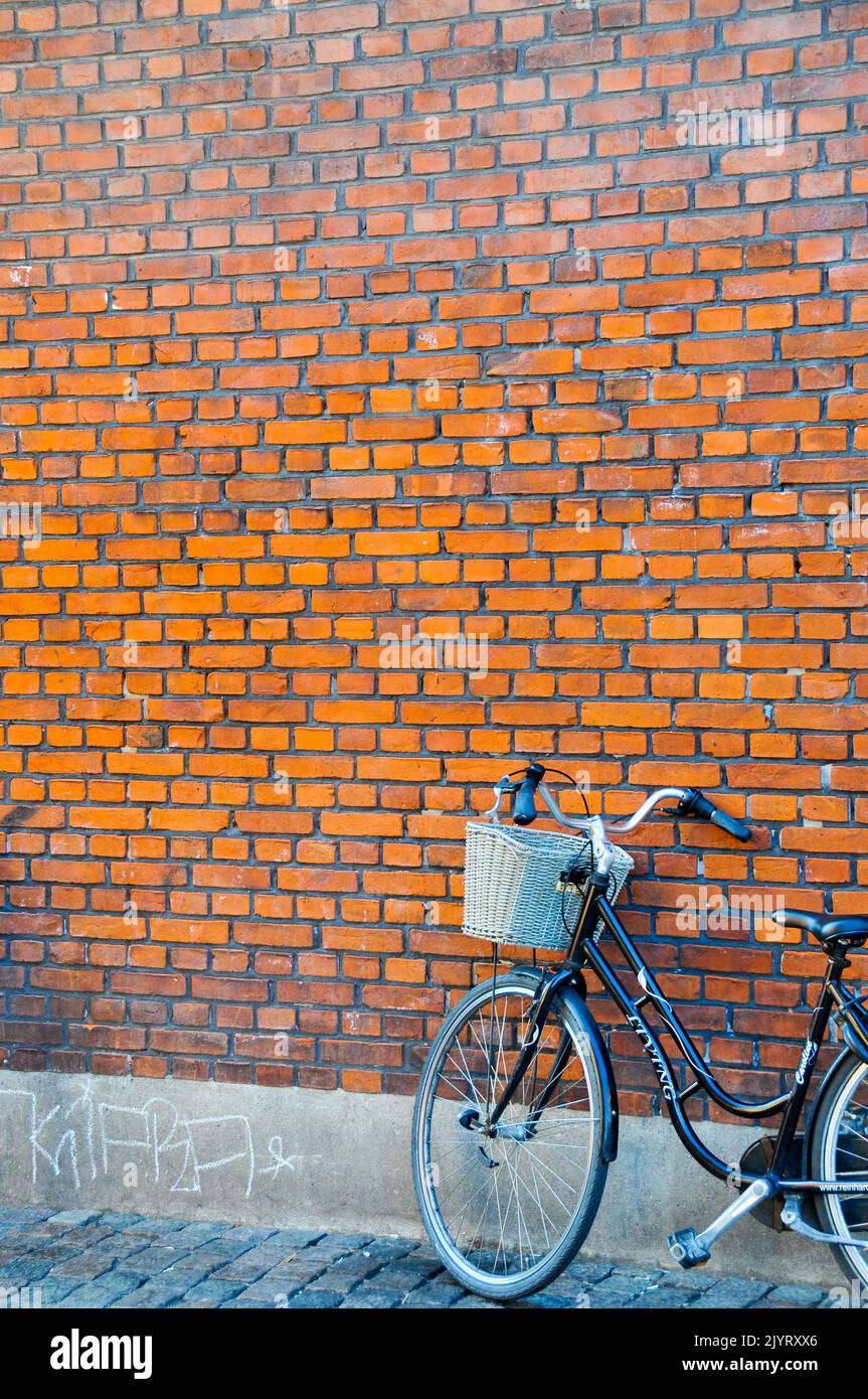 Bike in front of red brick wall Stock Photo - Alamy