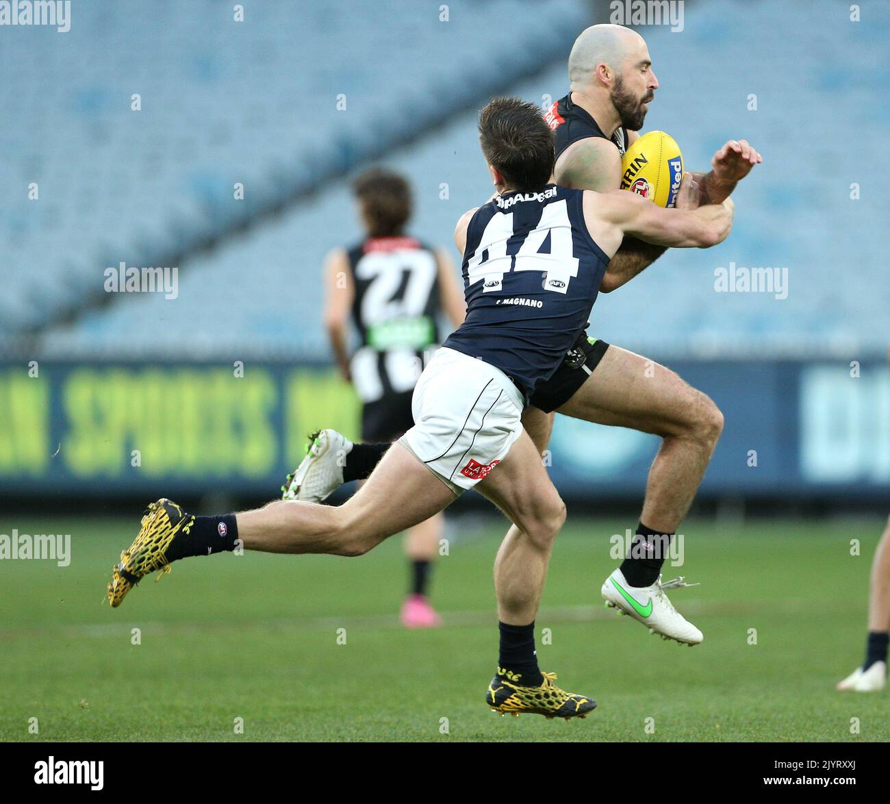 Steele Sidebottom of the Magpies is tackled by Matthew Owies of the ...
