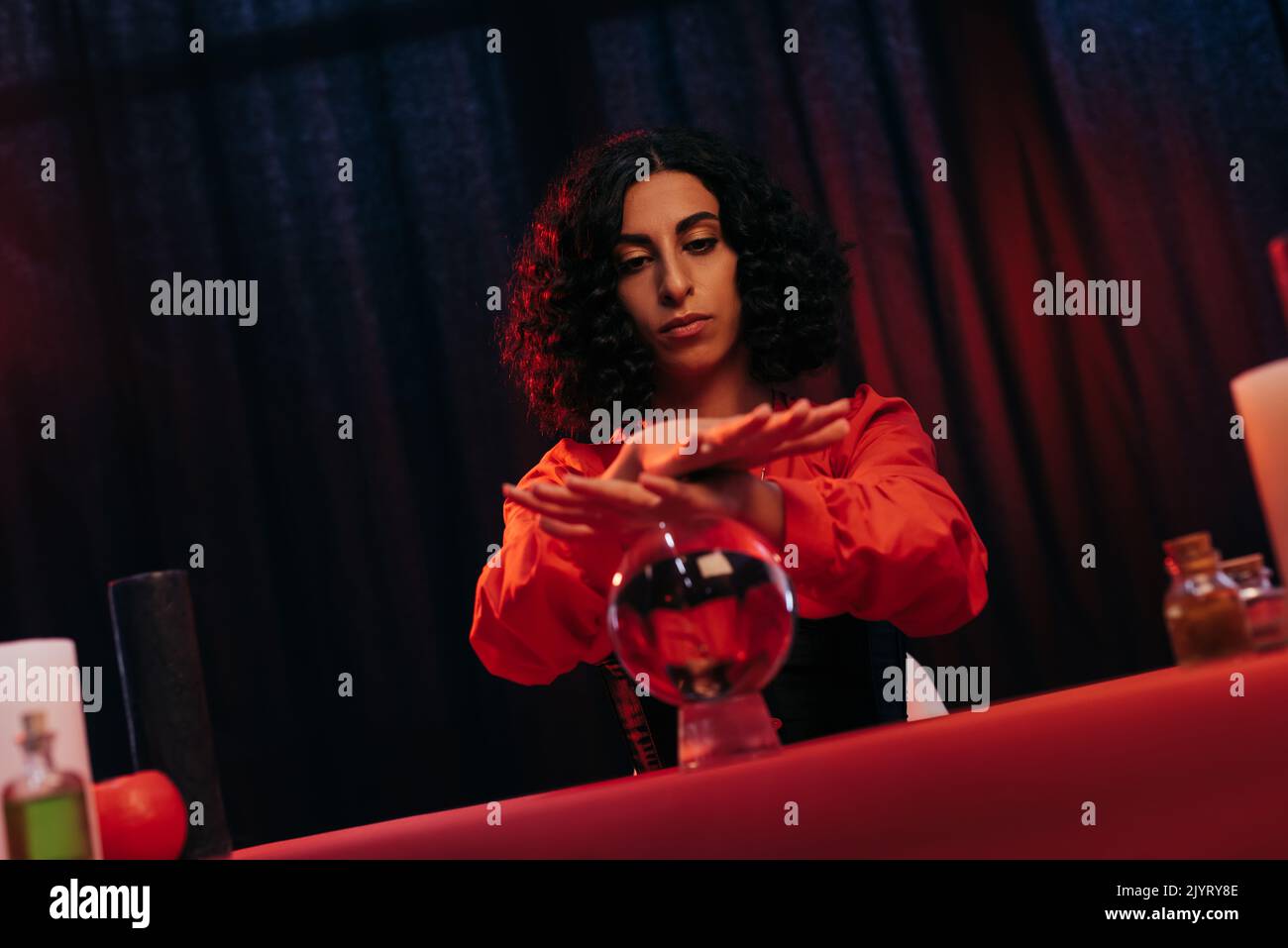 medium predicting future near crystal ball on dark draped background ...