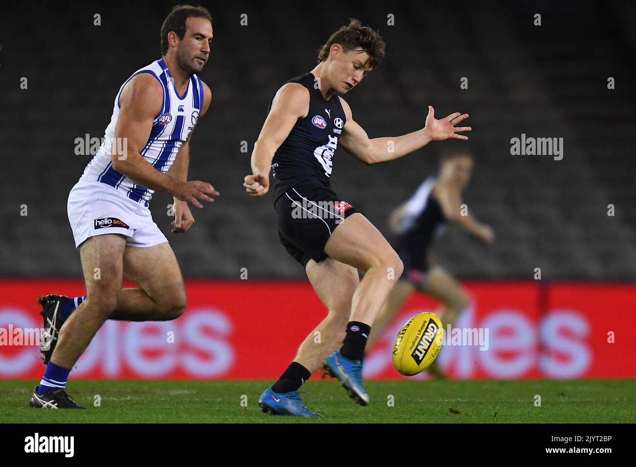Sam Walsh of Carlton Blues (right) kicks the footy during the AFL Round ...