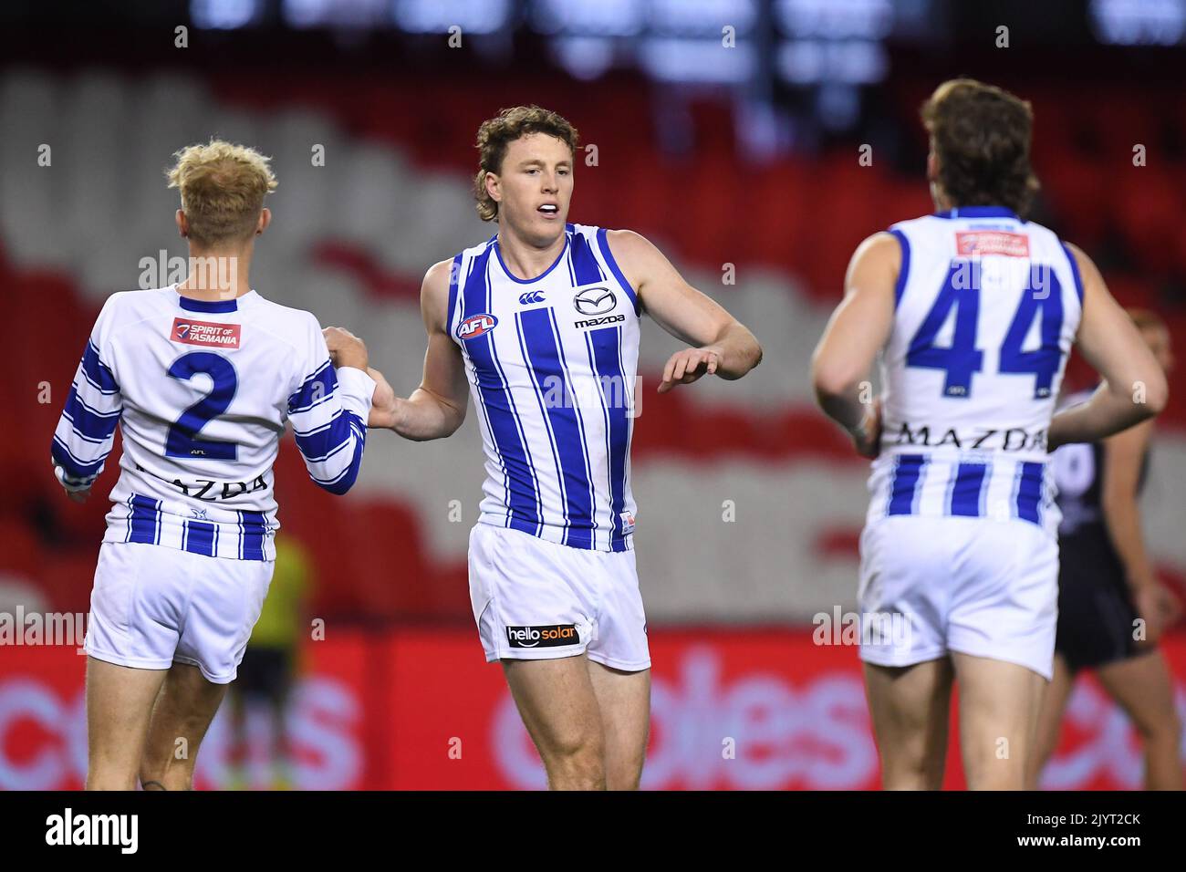 Nick Larkey of North Melbourne (centre) celebrates with team mates ...