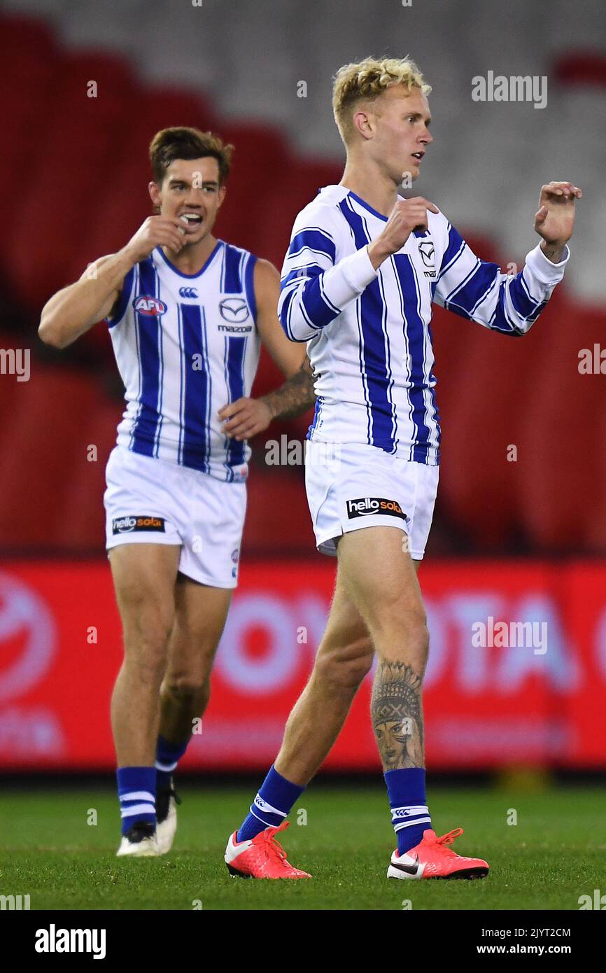 Jaidyn Stephenson of North Melbourne (right) celebrates with team mates ...