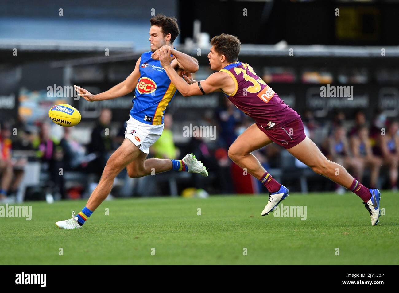 Jack Bowes (left) of the Suns takes on Zac Bailey (right) of the Lions ...