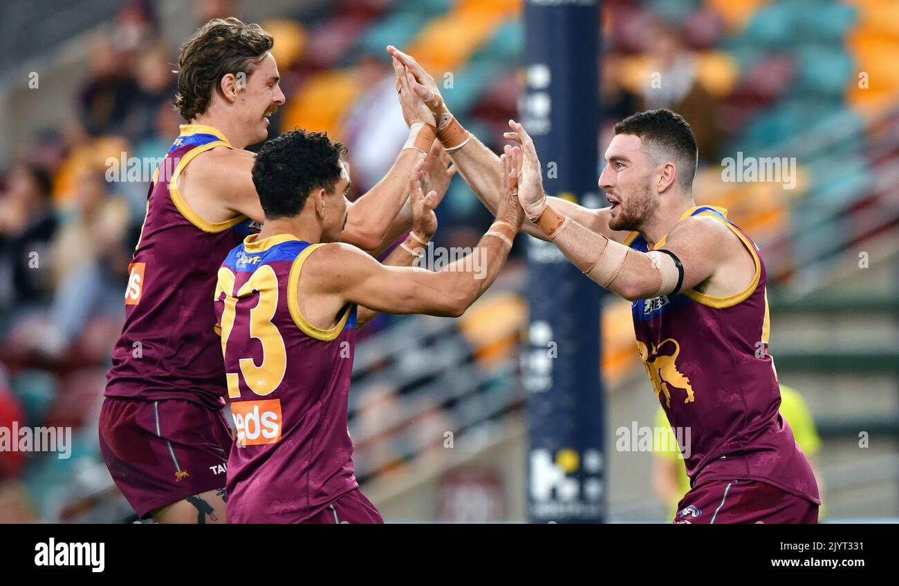 Daniel McStay (right) of the Lions celebrates kicking a goal with Joe ...