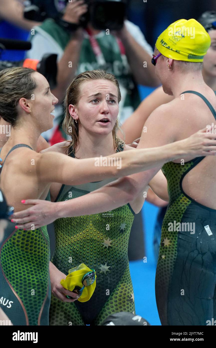 Emma McKeon (left) and Ariarne Titmus embrace Leah Neale of Australia ...