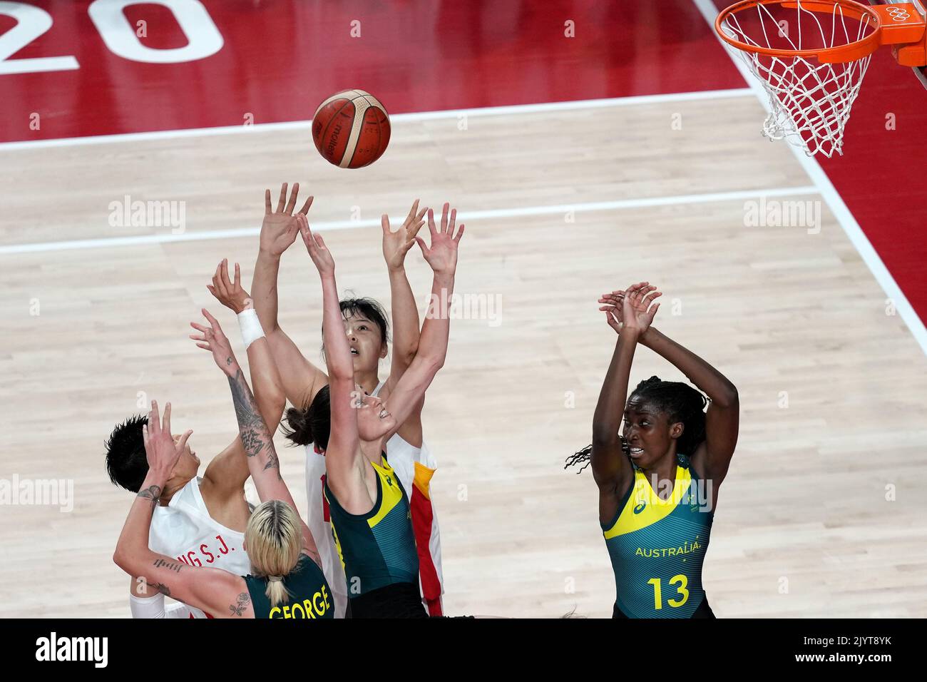 Bec Allen of Australia (centre) competes for the ball with Li Yueru of ...