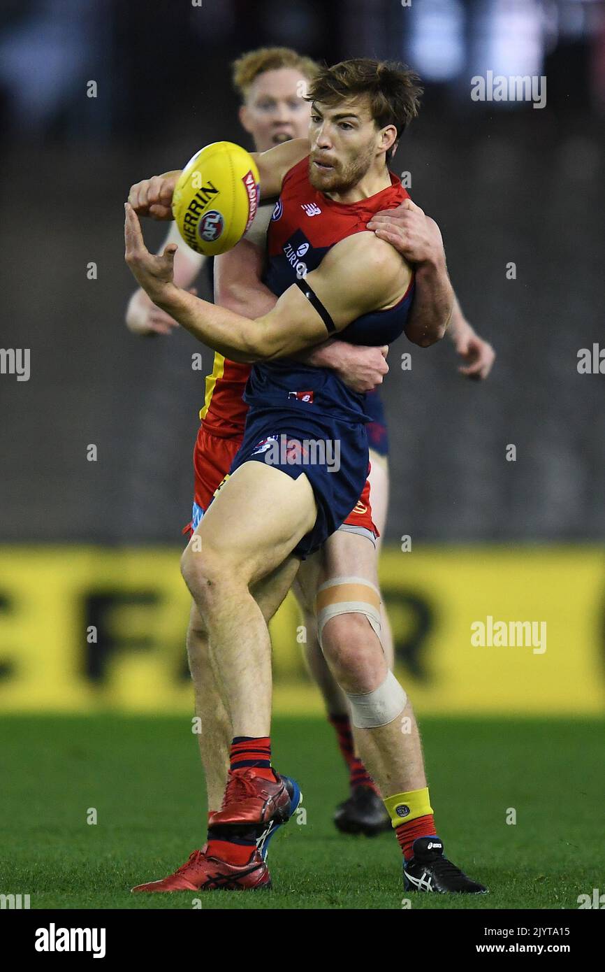 Michael Hibberd of the Demons (right) handballs the footy ** STRICTLY ...