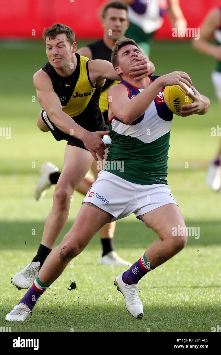 Luke Ryan of the Dockers is tackled by Jake Aarts of the Tigers during ...