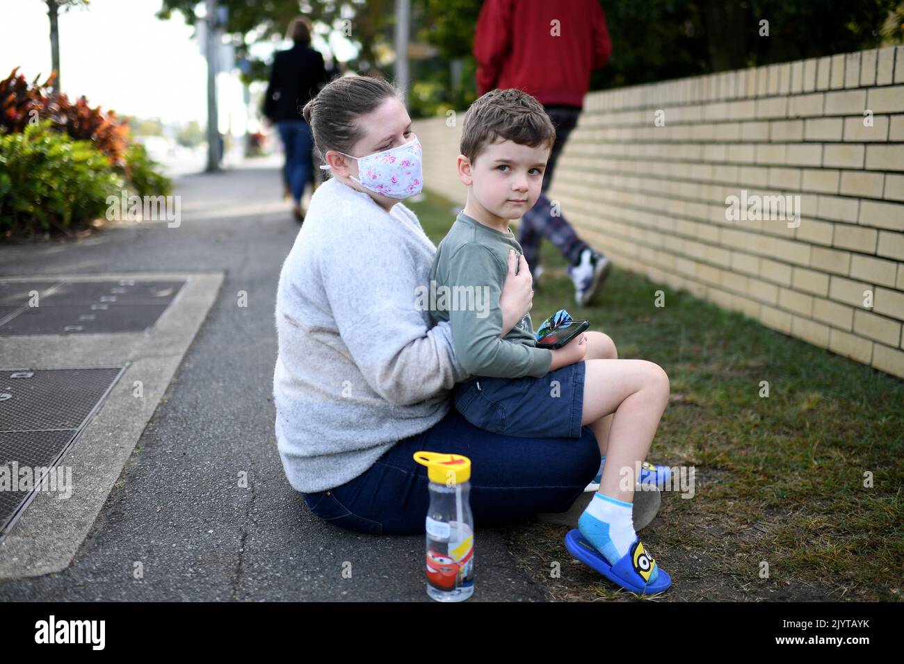 Sarah Dunstan and her 5 year-old son James queue up for a Covid-19 test ...