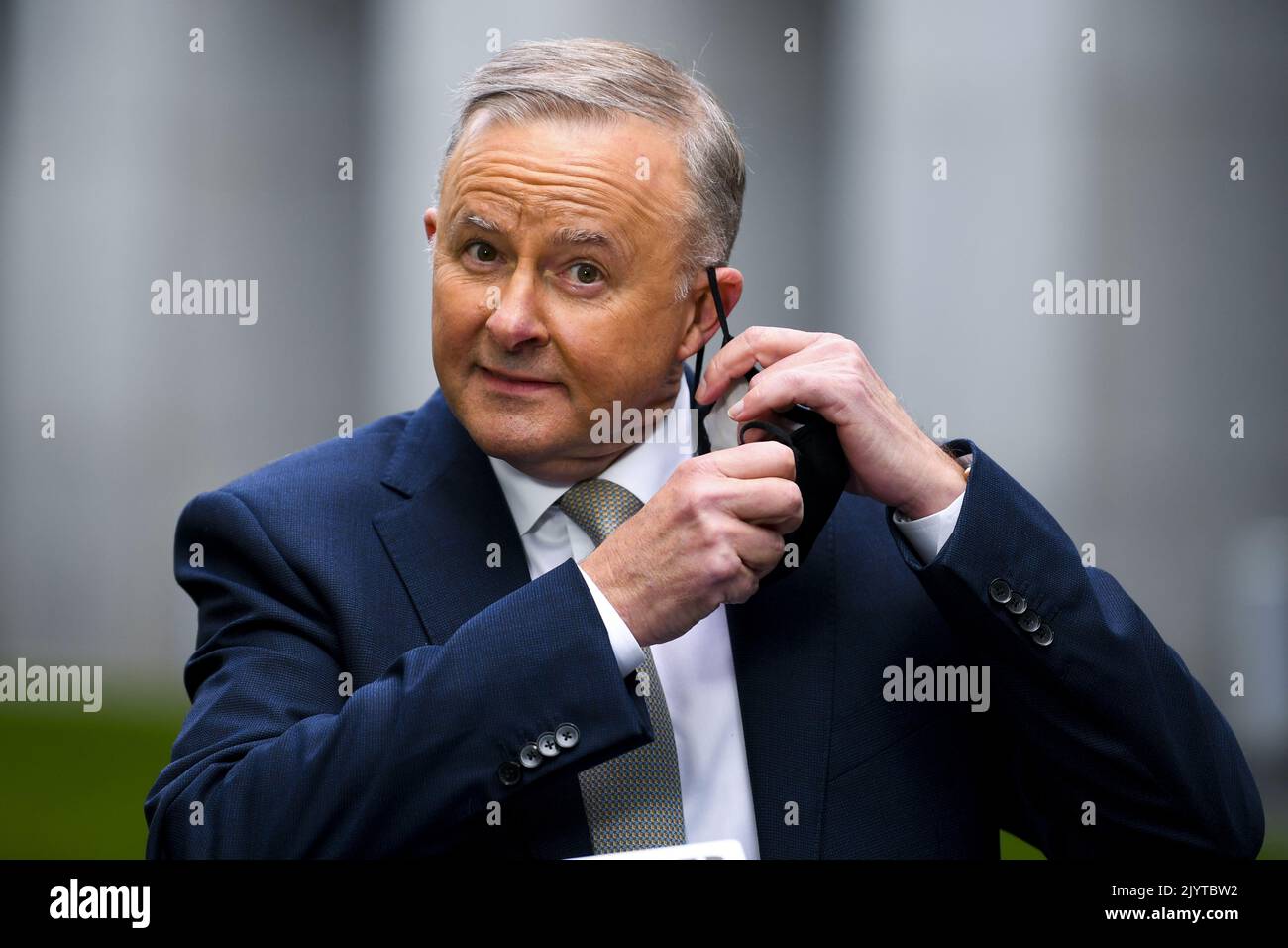 Australian Opposition leader Anthony Albanese removes his face mask ...