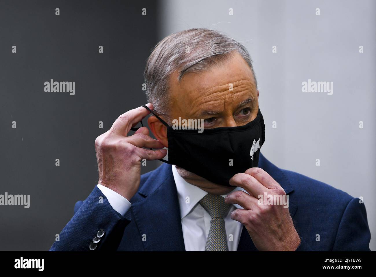 Australian Opposition leader Anthony Albanese removes his face mask ...