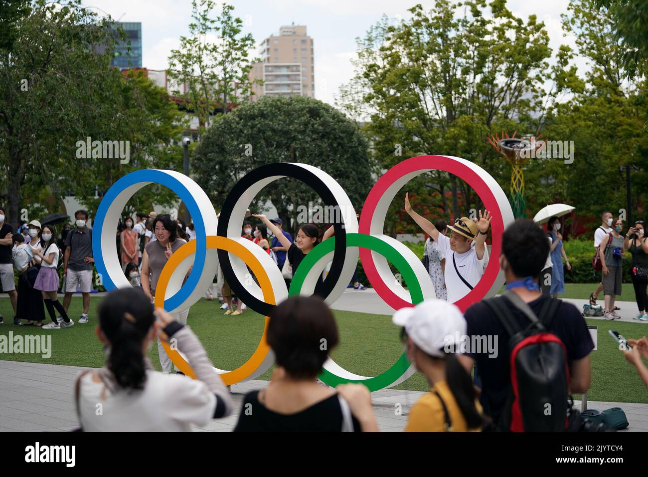 People pose for photographs with the Olympic rings at the Olympic ...
