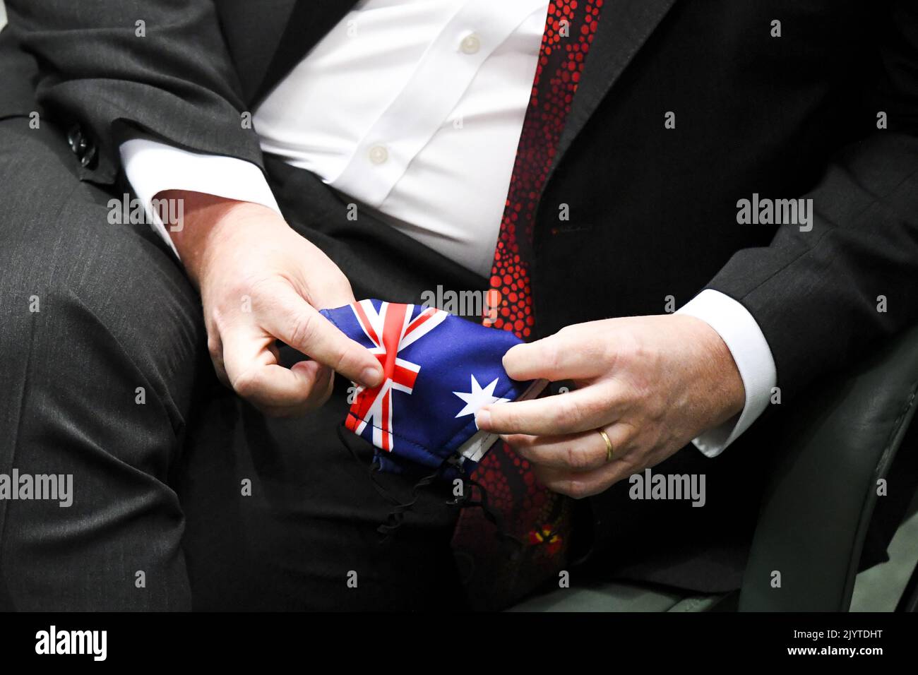 Australian Prime Minister Scott Morrison holds his face mask depicting ...
