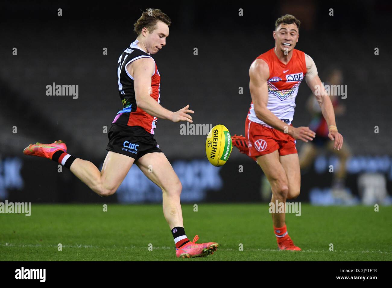 Zak Jones of St Kilda (left) kicks the footy during the AFL Round 21 ...
