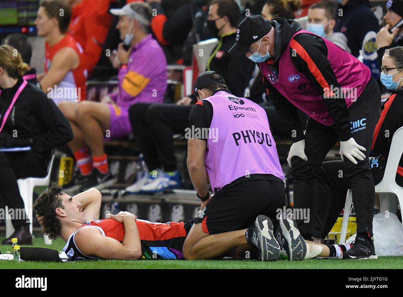Max King of St Kilda (left) is attended to by a physio on the ...