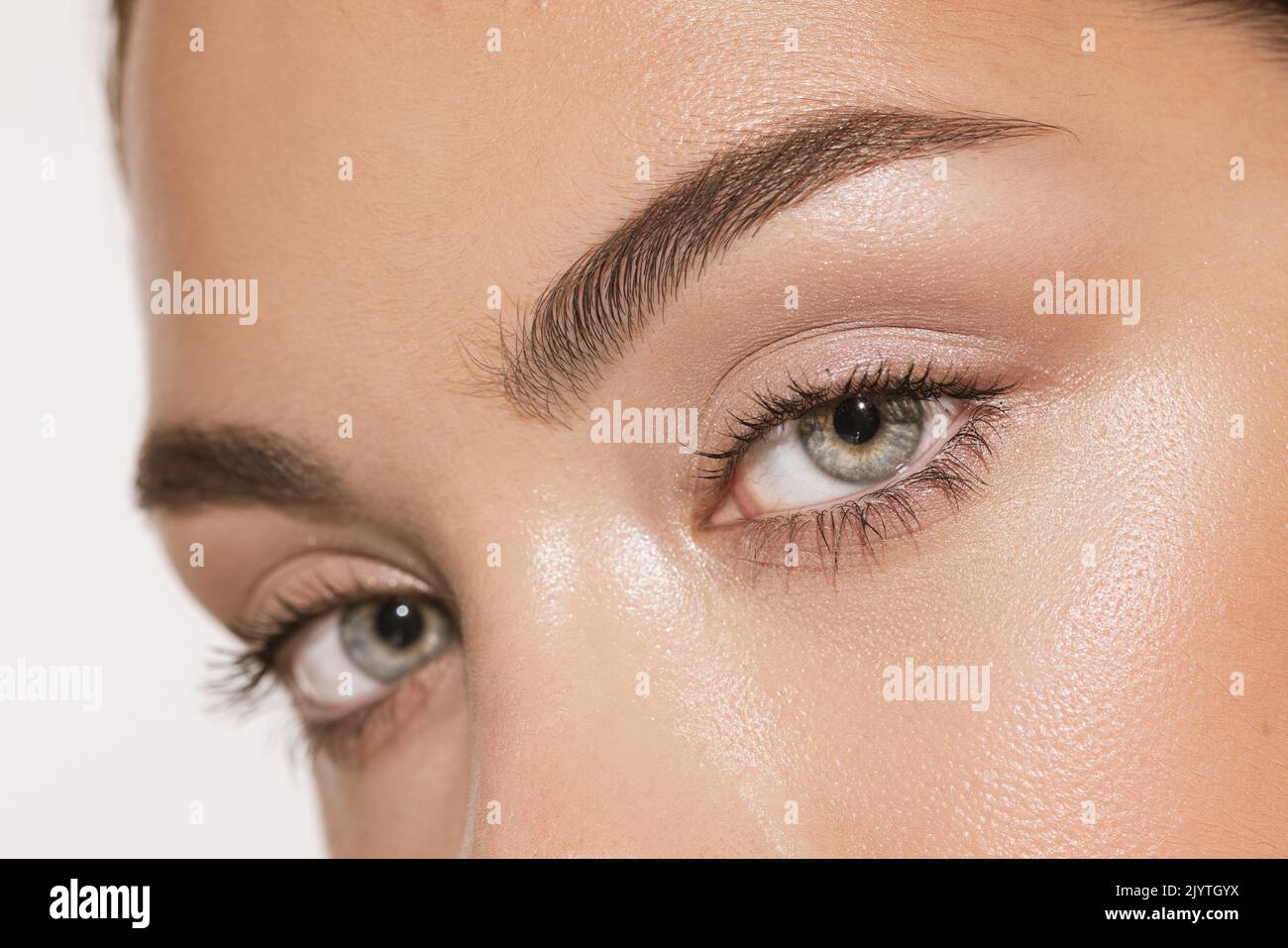 Grey eyes and perfect shapes of eyebrows. Close up portrait of beautiful young girl looking at ...