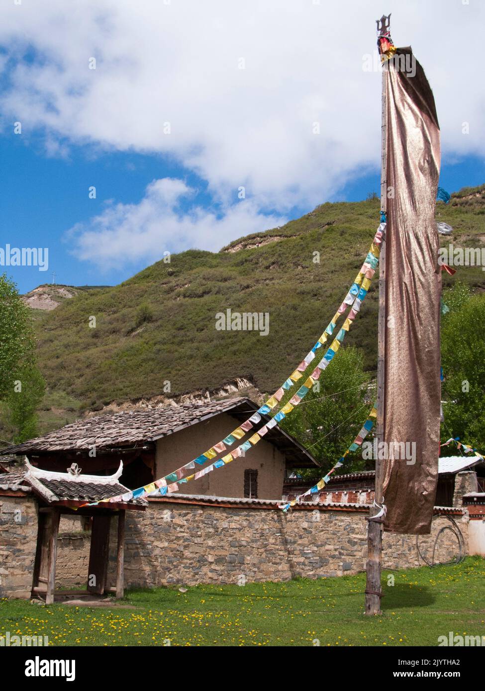 Public Buddhist prayer flags in front of a temple practising Buddhism ...