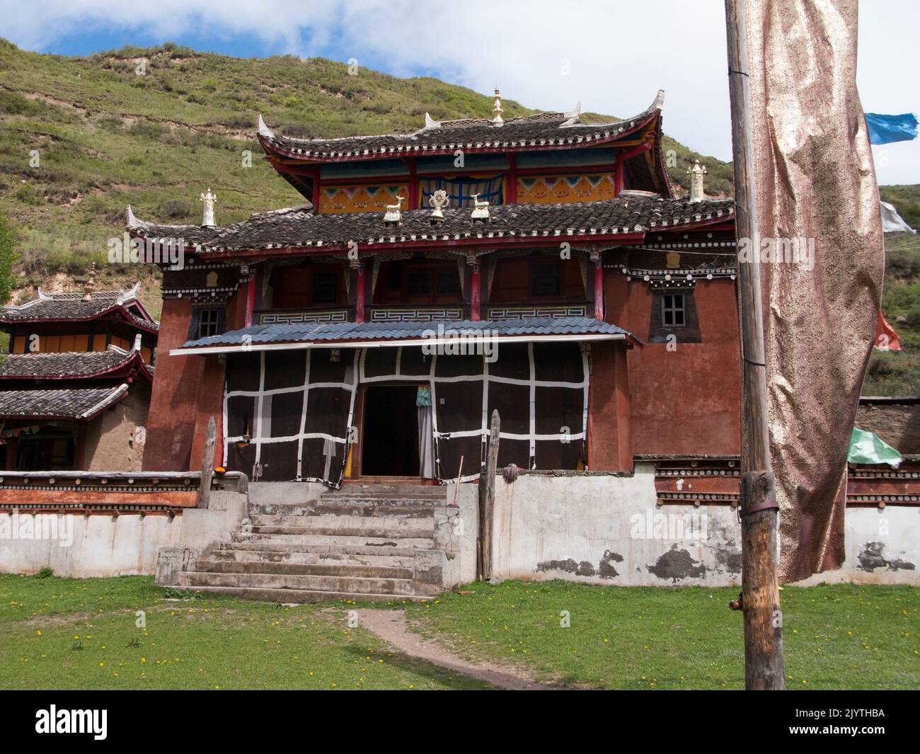 Public Buddhist prayer flags in front of a temple practising Buddhism ...