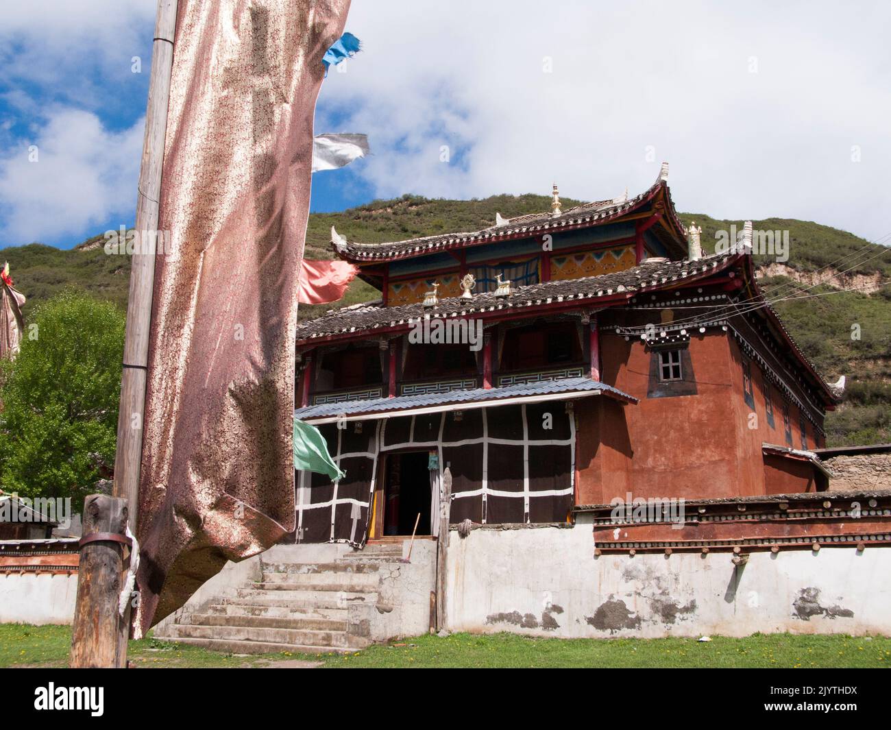Public Buddhist prayer flags in front of a temple practising Buddhism ...