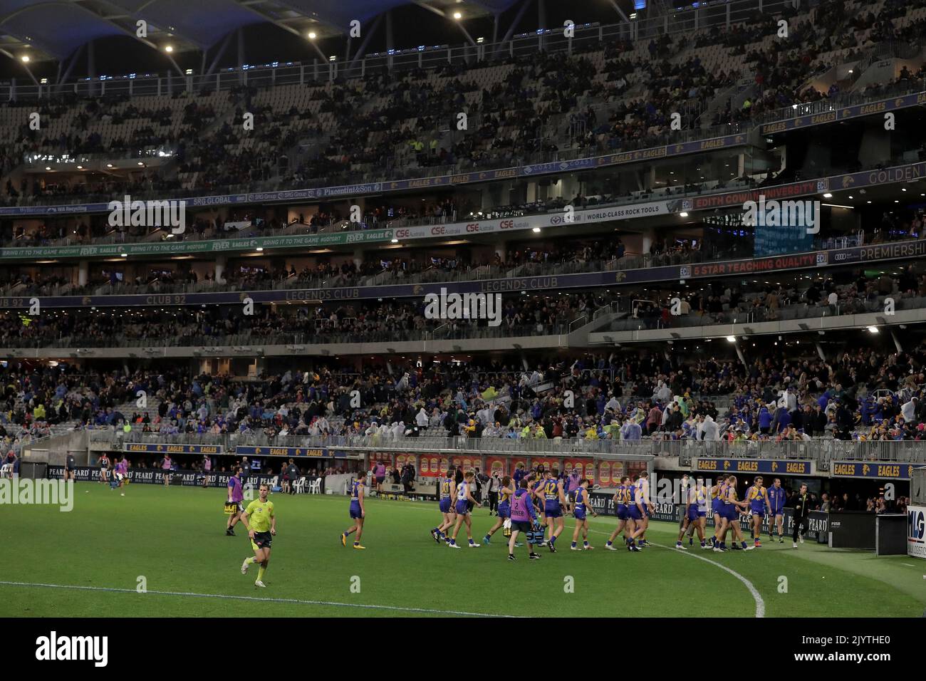 Players leave the field after a Severe Weather warning is given during ...