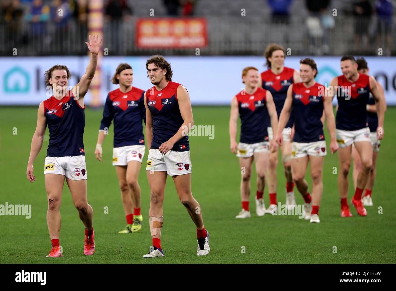 Demons players celebrate after winning the Round 21 AFL match between ...
