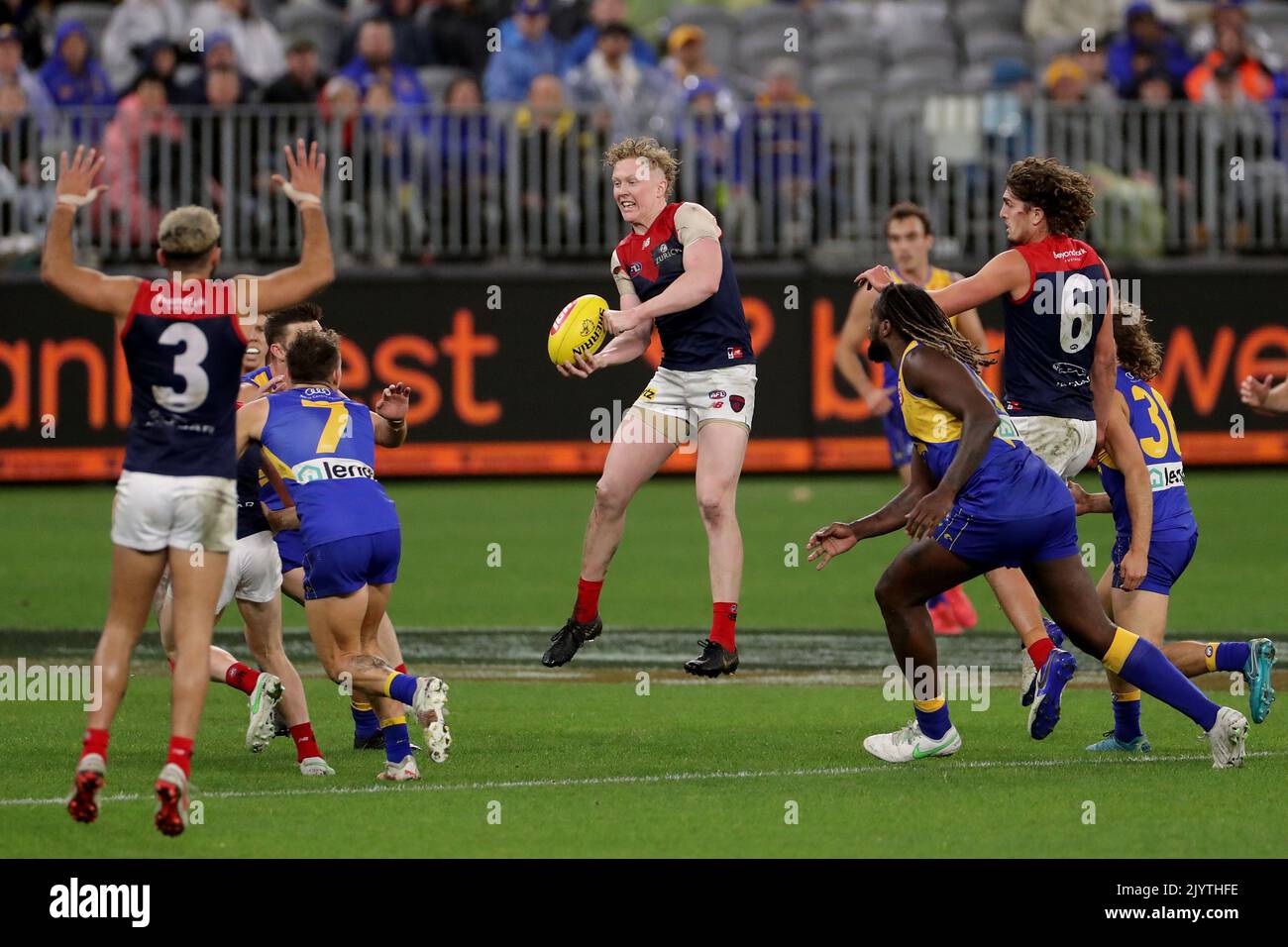 Clayton Oliver of the Demons handballs during the Round 21 AFL match between the West Coast ...