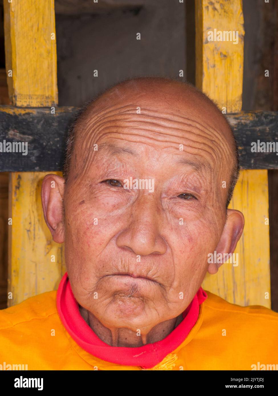 Portrait of local person wearing Buddhist clothes, an elderly old man ...