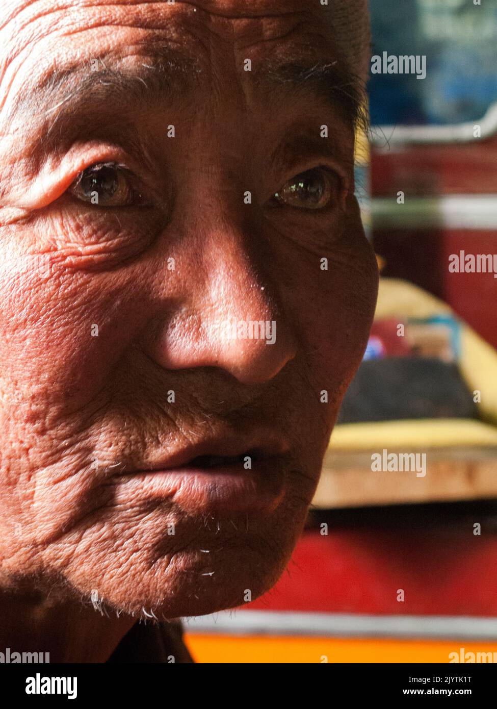 Portrait of an ethnic Tibetan man during a visit to his house by a ...