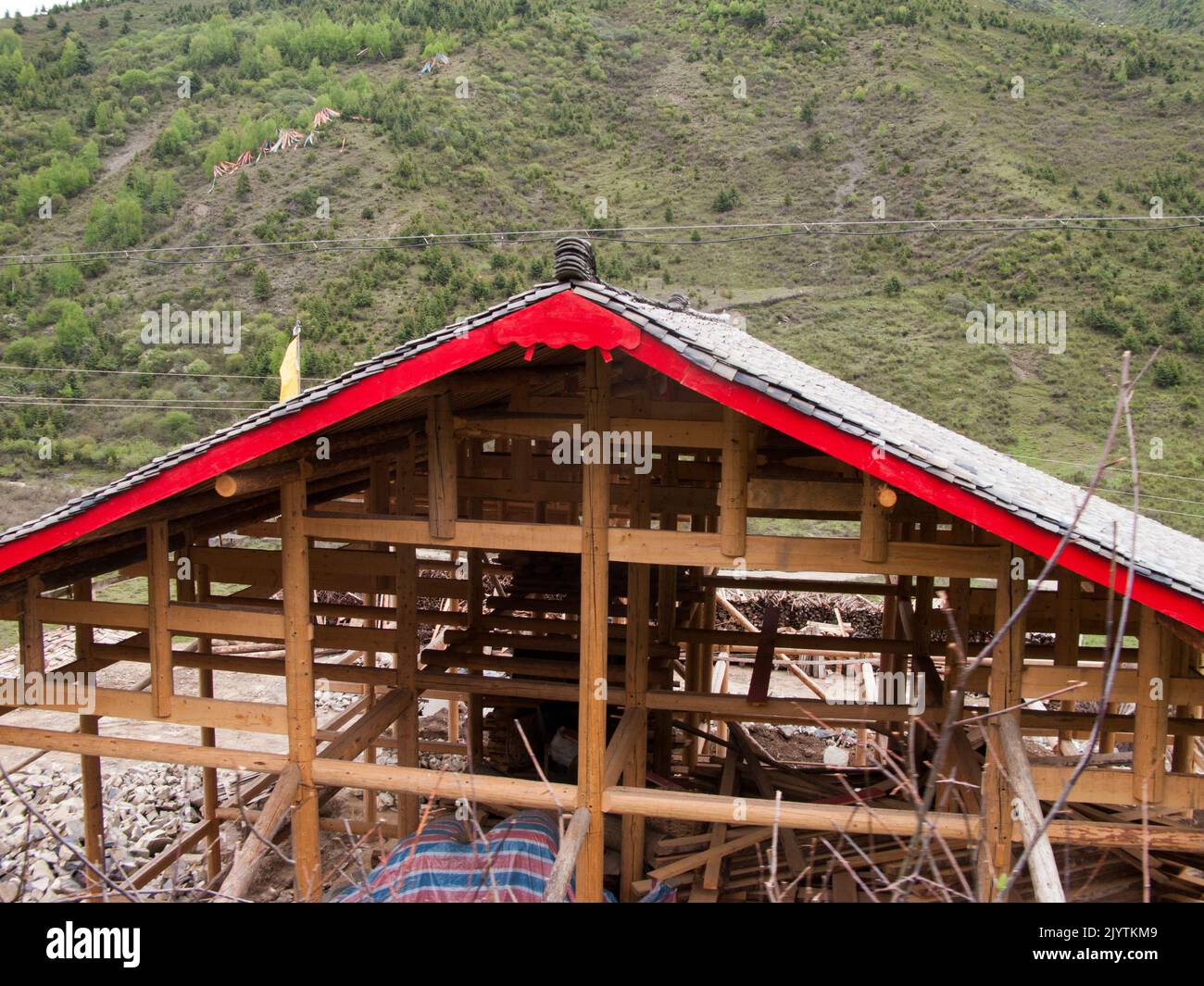 Timber framed house / building being built, it's roof already completed ...
