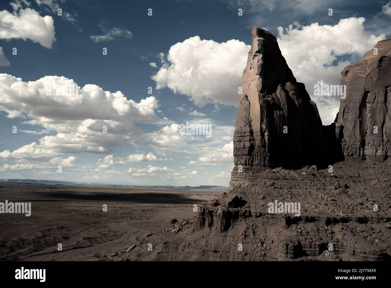 A gigantic freestanding needle like rock in Monument Valley raises in ...