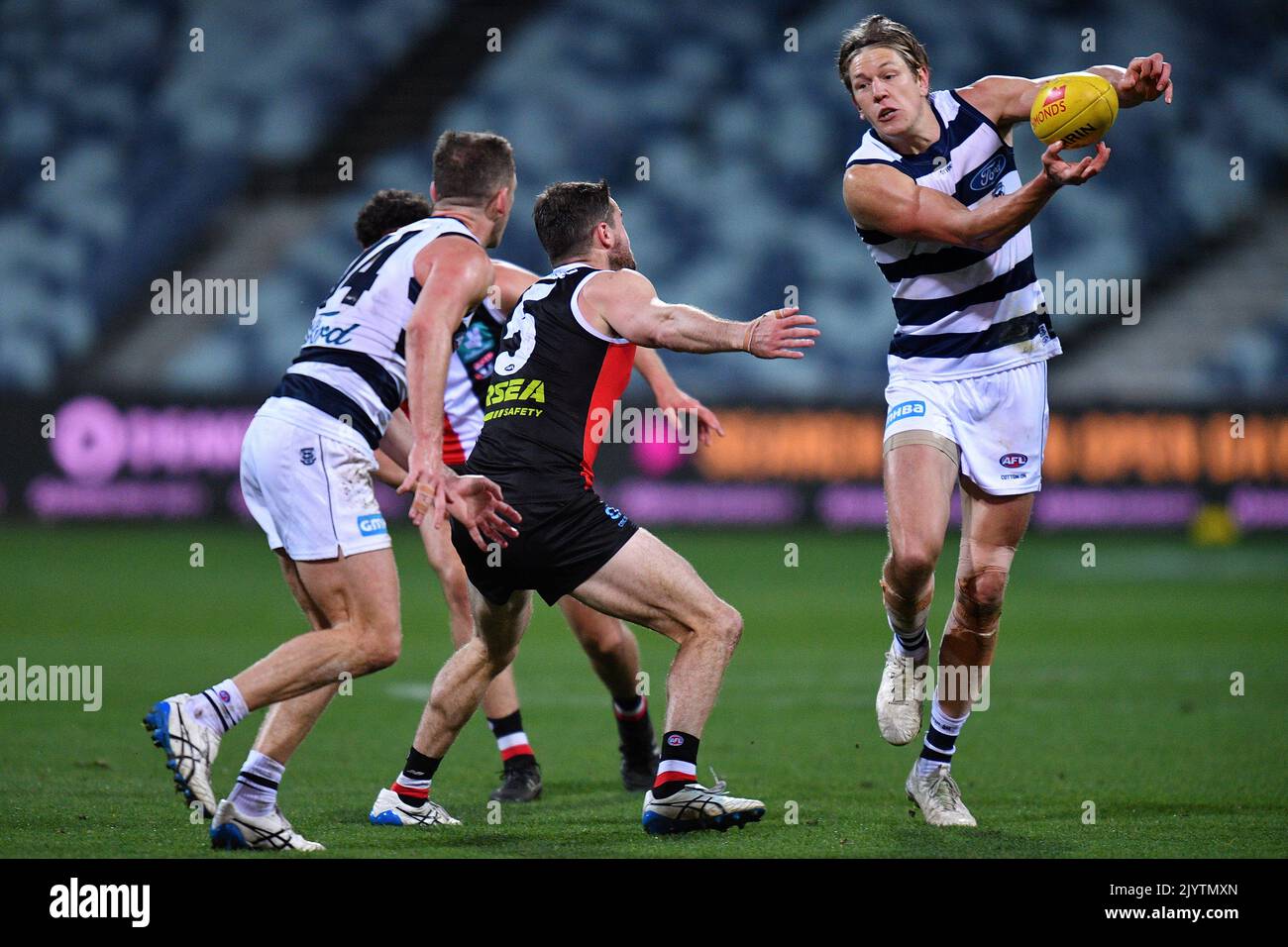 Rhys Stanley of Geelong (right) handballs the footy during the AFL ...