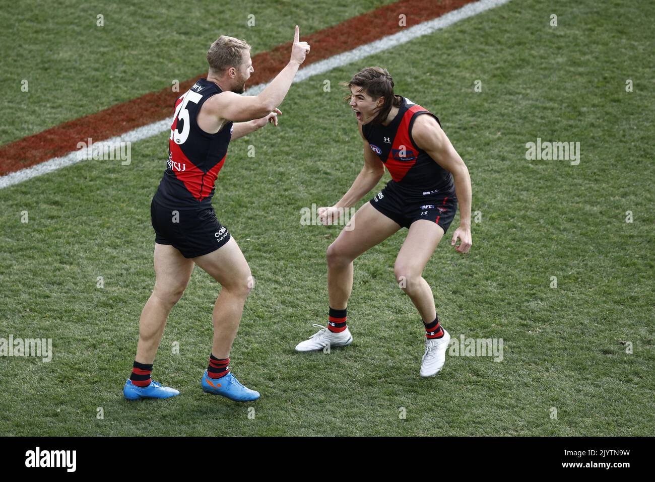 Jake Stringer of the Bombers (left) celebrates a goal during the AFL ...