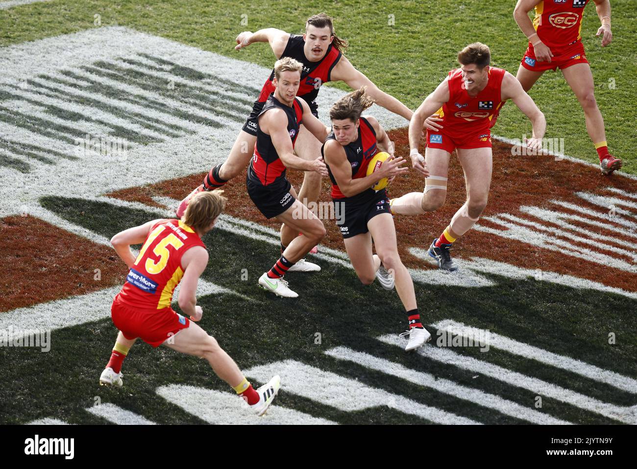 Sam Durham of the Bombers (centre) runs with the ball during the AFL ...