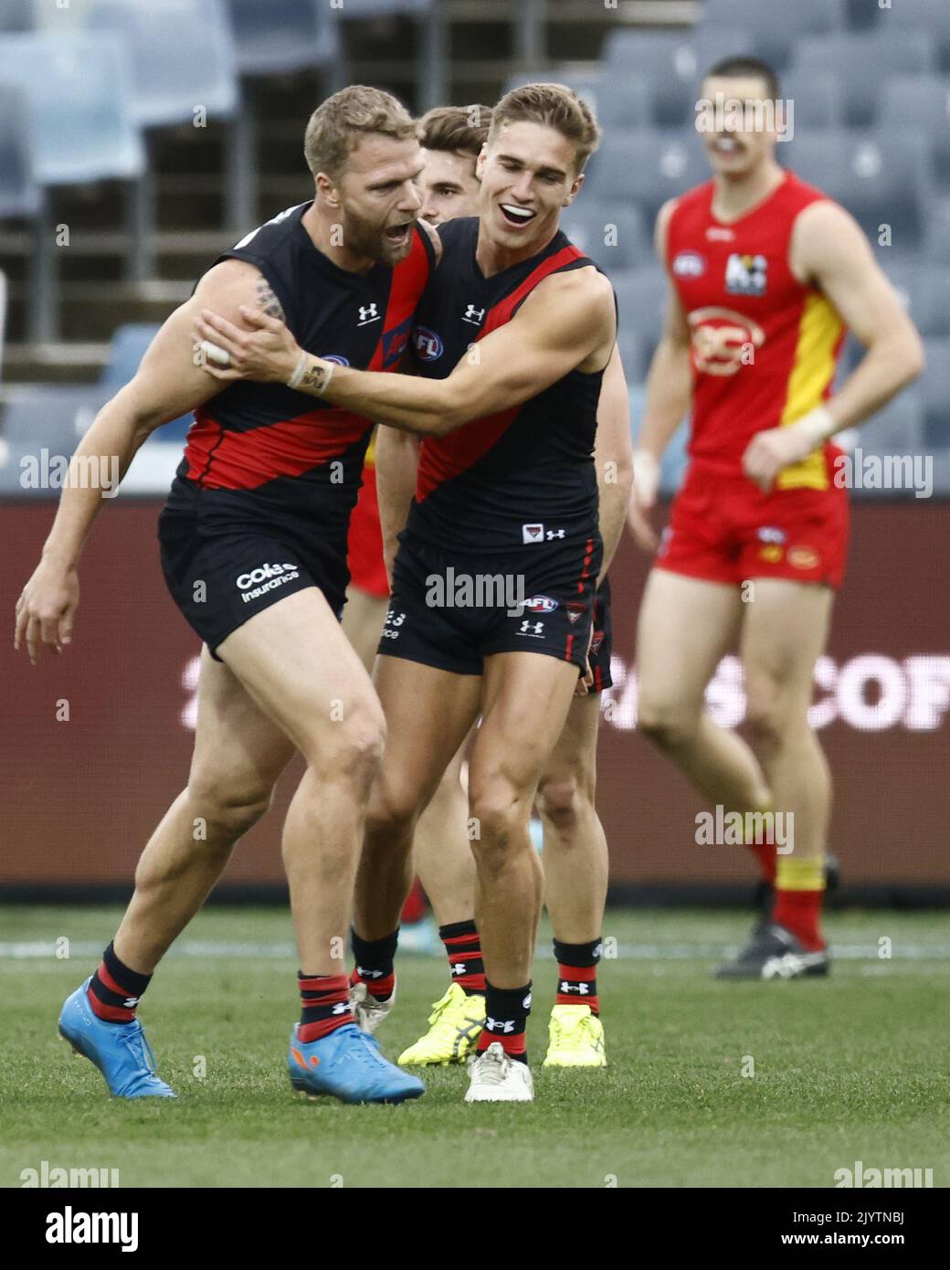 Jake Stringer of the Bombers (left) celebrates a goal during the AFL ...